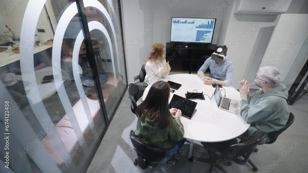 A diverse group of businessmen collaborates and tests a new virtual ...