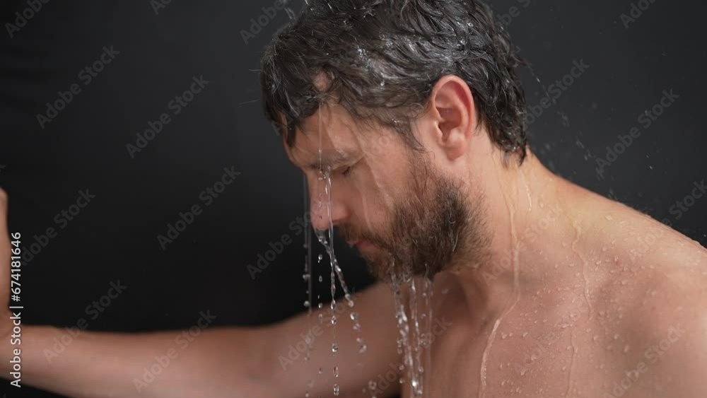 Man washing hair in bath. Guy bathing shower head in bathtub. Face in ...