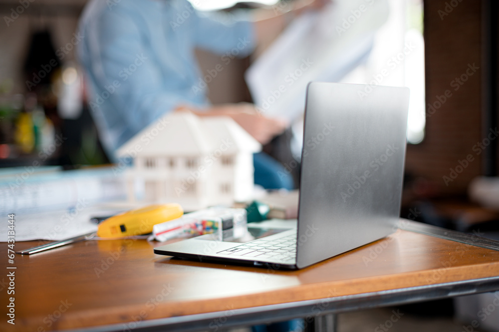 Male engineer or architect wearing shirt holding blueprint working on ...