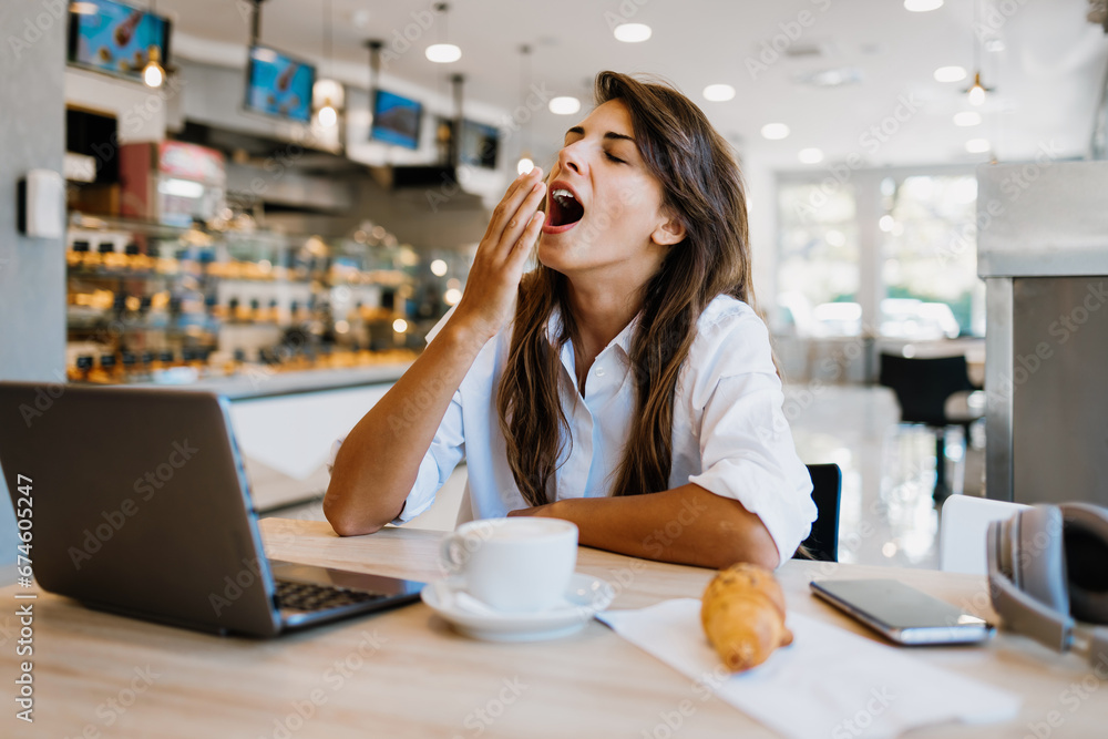 Beautiful and happy young woman sitting and eating delicious rolls in ...