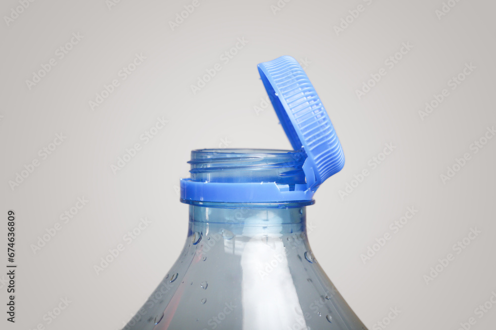 Close up of new cap attached to plastic bottle, connected to the neck ...