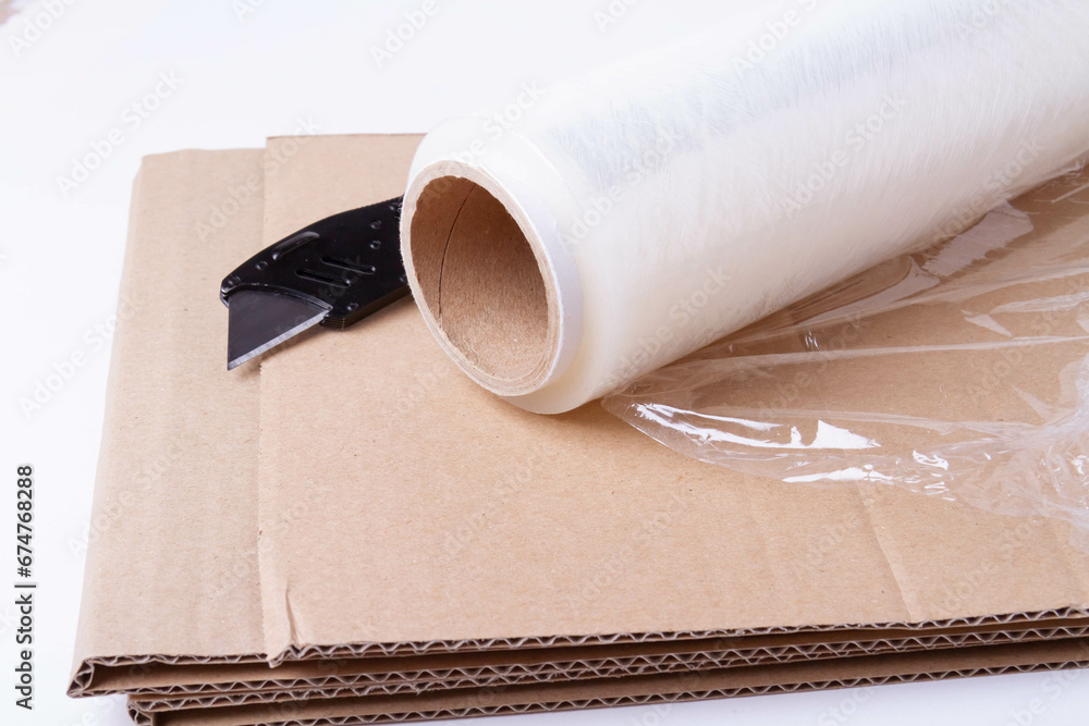 Foto de Packing the goods in a cardboard box and stretch film. Tools ...