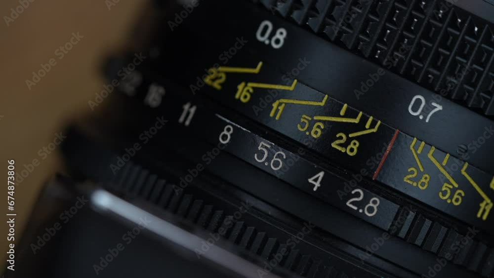 An old camera lens close up. The lens, focus and exposure controls of a ...