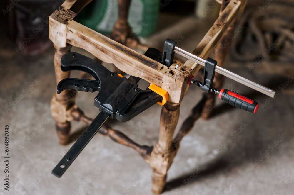 Clamp, a special tool for gluing and fixing a wooden chair in the ...