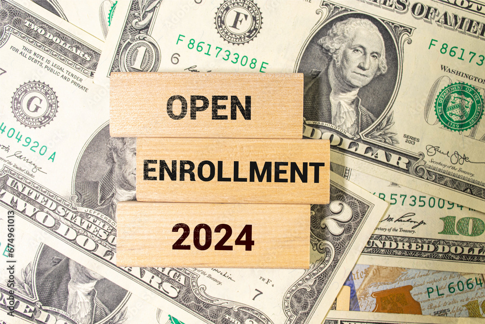 open enrollment 2024. text on a sticker next to money and banknotes ...