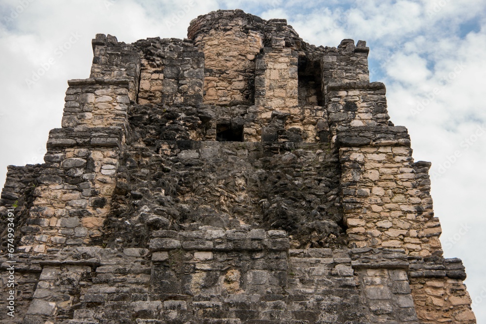 Image of the ancient Mayan ruins taken from a low angle, set against a ...