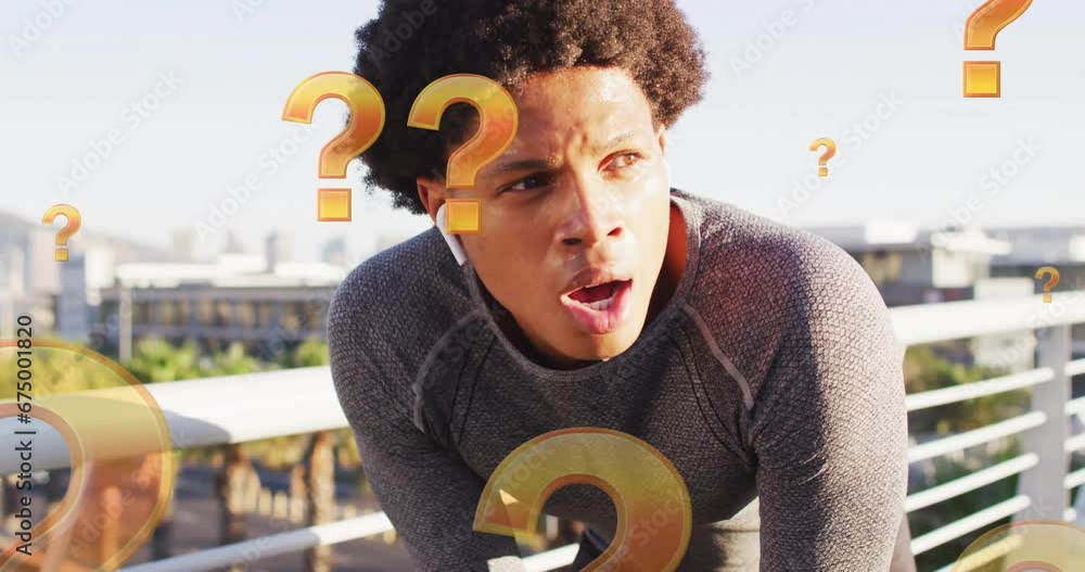 Animation of question mark symbols over tired biracial athlete standing ...