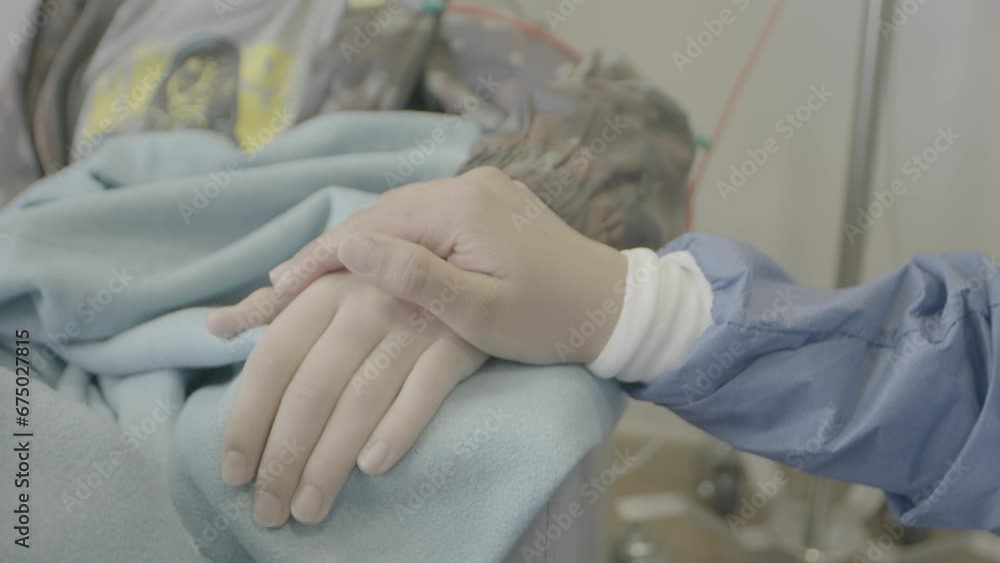 A person in the hospital receiving hand touches and support from family ...