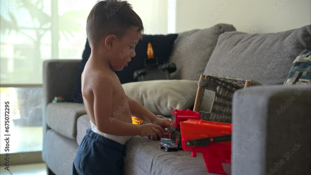 Young little latin hispanic boy shirtless wearing shorts and diapers ...