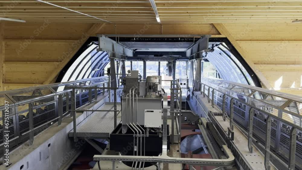 The drive wheel of a chairlift. The large flywheel drives the cable of ...