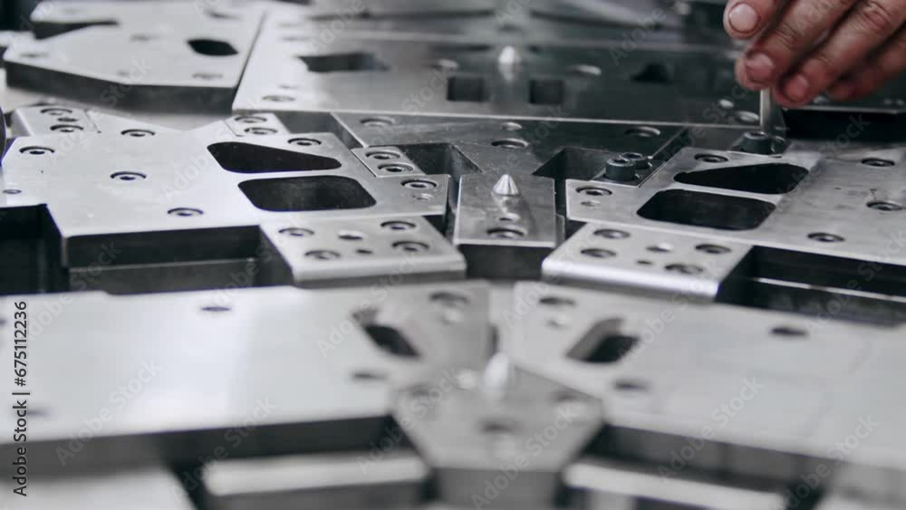 Close up of a big metal shaping tool being put together after ...