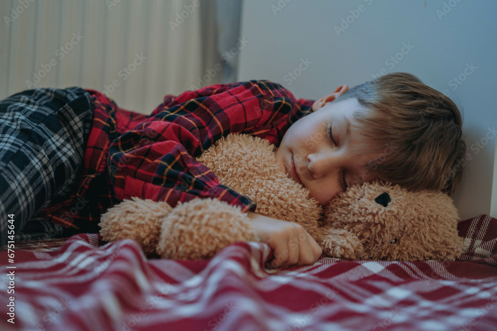 e boy falling asleep by heater hugging teddy bear waiting for santa ...