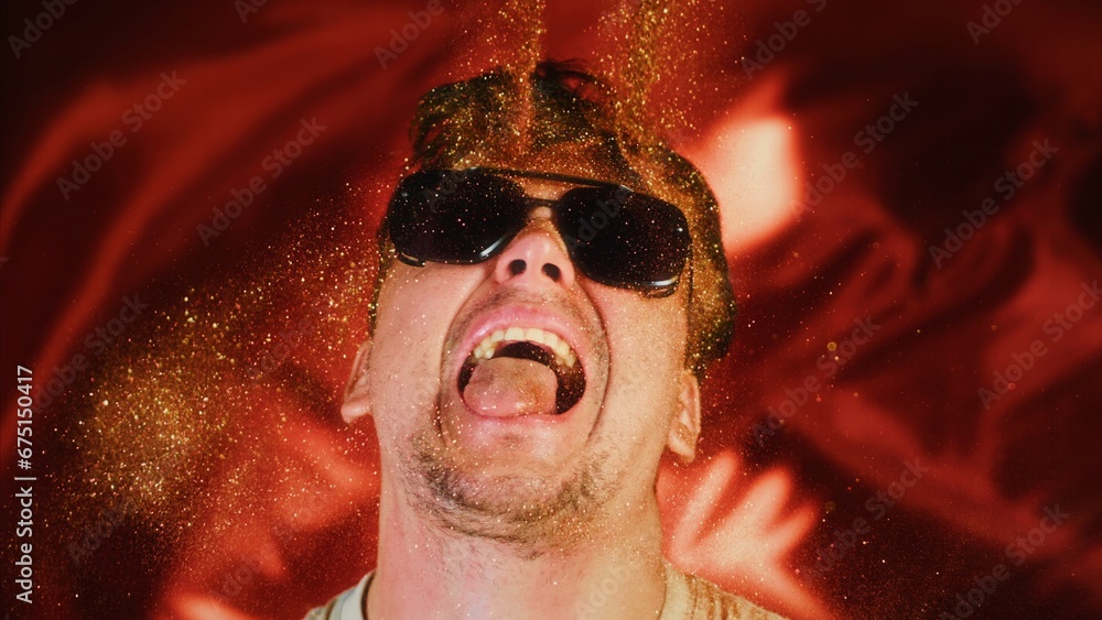 Crazy fun man sprinkles himself with sparkle particles. Fun photo funny ...