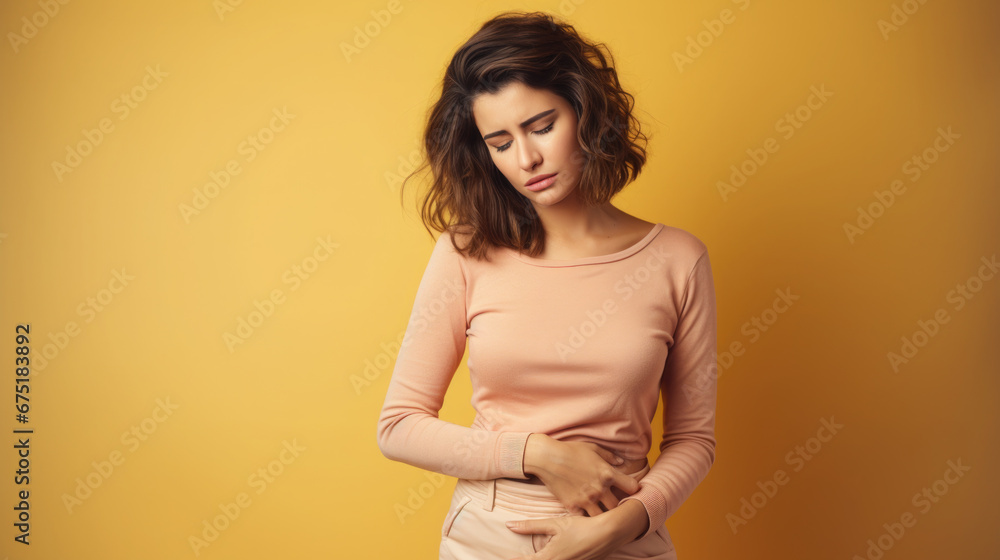 sad young woman holding her stomach, illness, cramps, health, color ...