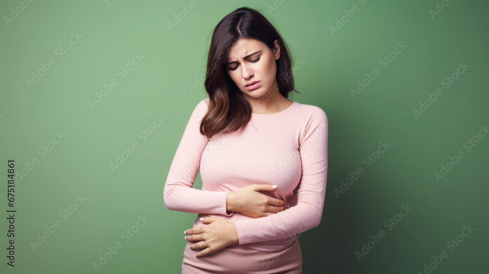 sad young woman holding her stomach, illness, cramps, health, color ...