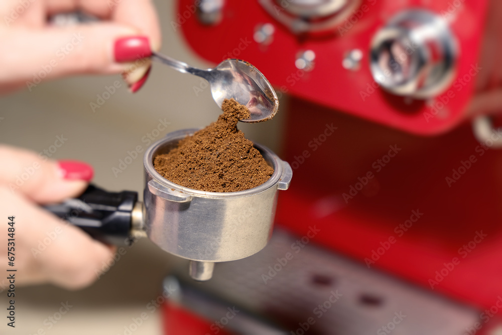 Freshly ground coffee in a port filter horn for a coffee machine. Close ...