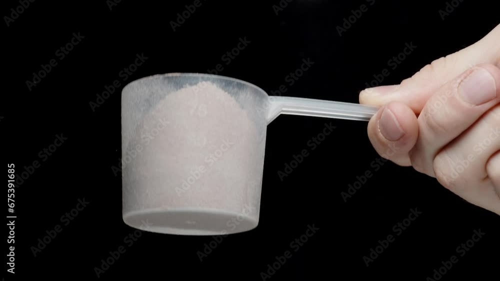 Top view on a black background as I sprinkle protein powder all around ...