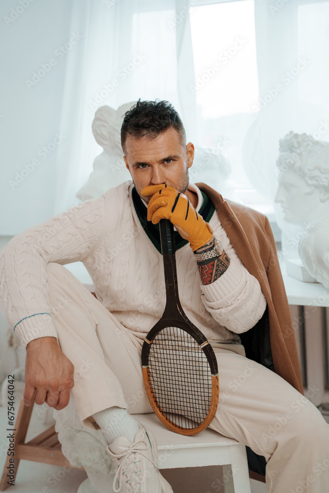 A dapper model in old money style, sitting among ancient Greek ...