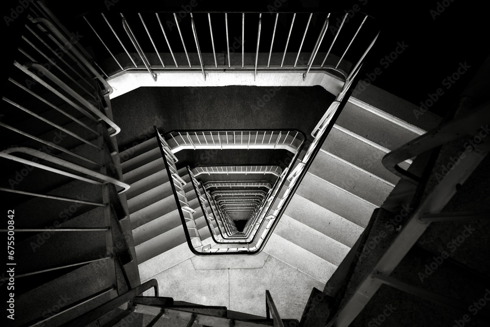Top view of a modern spiral staircase leads to the upper levels of a ...