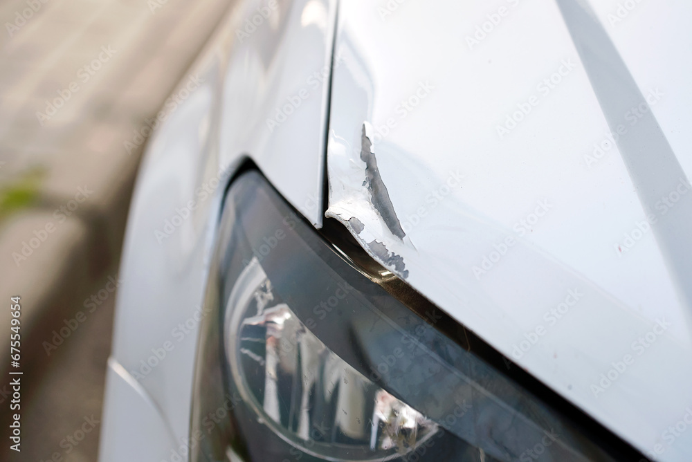 Damaged car hood, crumpled hood corner close up. Car after minor ...