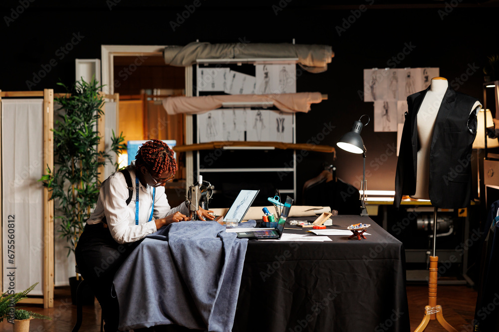 Seamstress using industrial sewing machine to do creative embroidery on ...