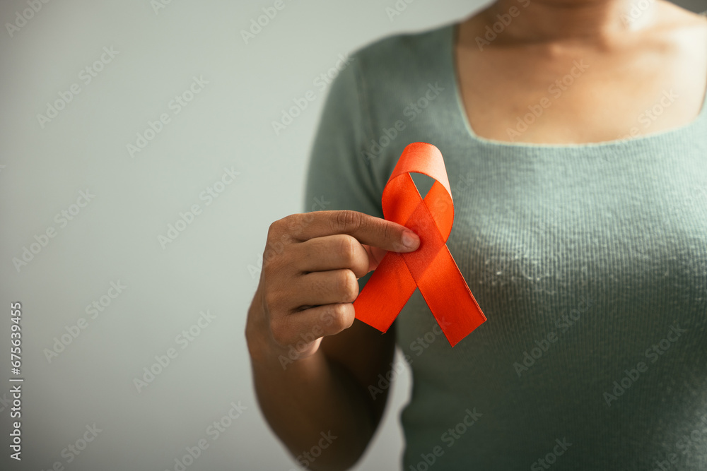 In a studio shot, a woman in uniform proudly displays an HIV AIDS ...