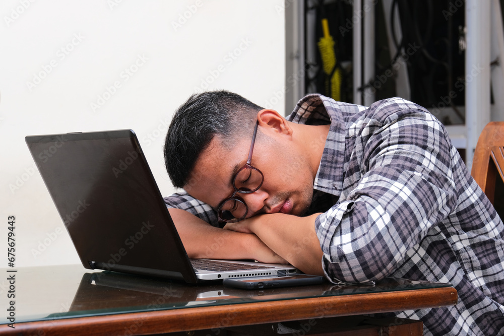 Adult Asian man sleeping in front of his laptop showing tiredness Stock ...