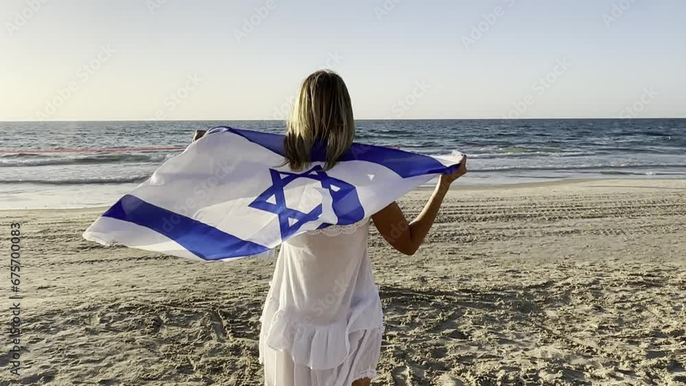 girl in white clothes hold Israeli flag in two hands above head ...