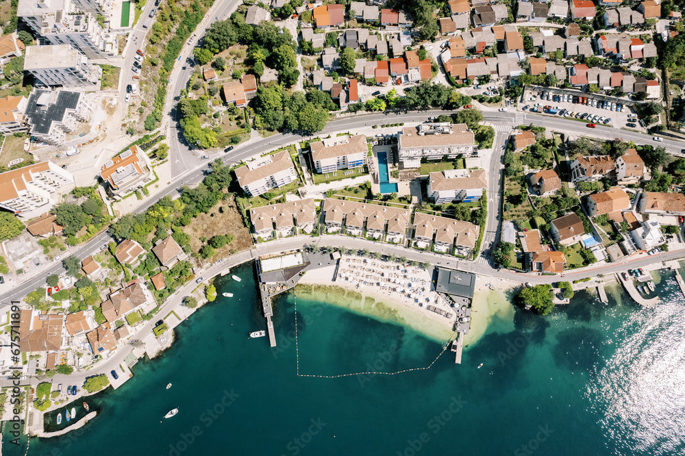 Brown roofs of the Huma Kotor Bay Hotel with a private beach. Dobrota ...