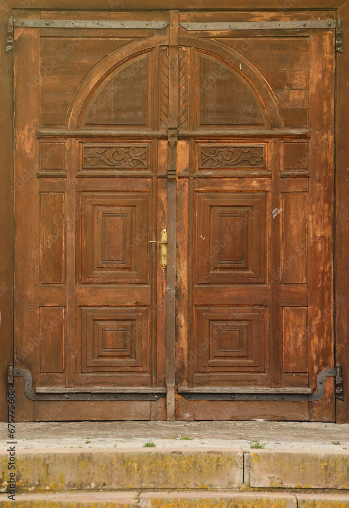 Very old solid wooden door in retro 19th century design close up ...