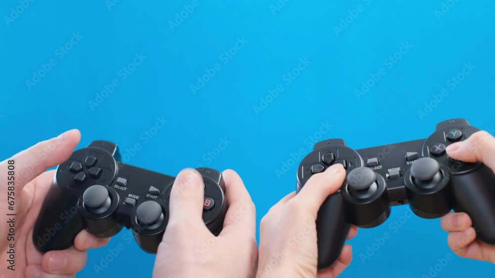Two game controller isolated on blue background Stock Video | Adobe Stock