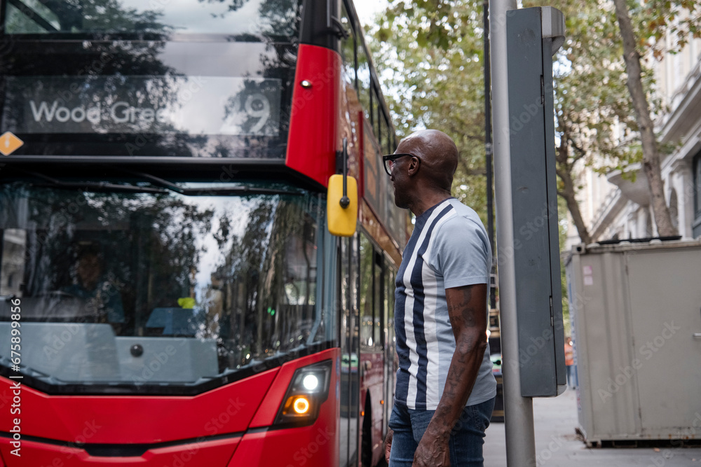 UK, London, Mature man posing next to double decker bus Stock Photo ...