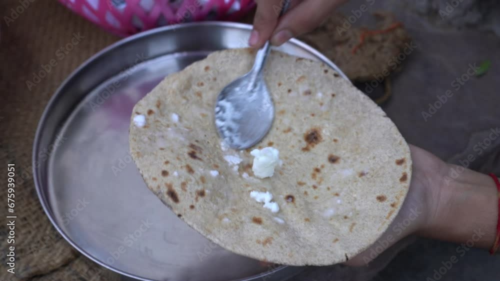 Making roti or Indian Chapati on roti tawa made of wheat with hand ...