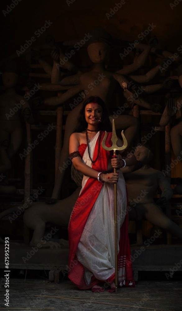Portrait of beautiful Indian girl of Durga Idol Agomoni Concept Indoor ...