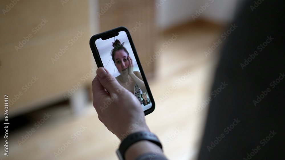 Friends speaking on video conference. Close-up hand holding smartphone ...