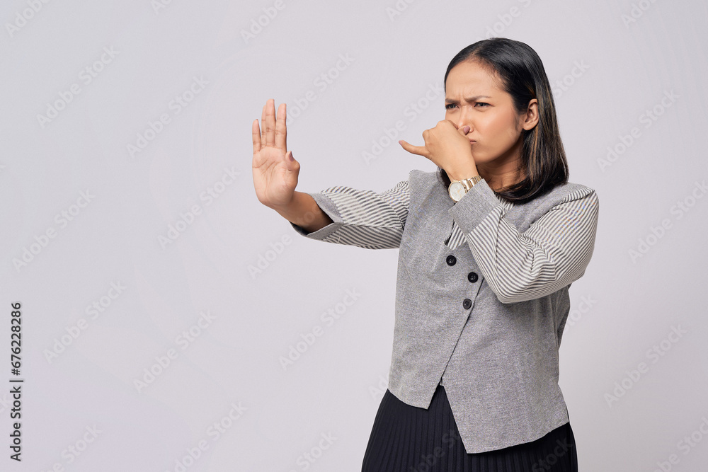 Young Asian woman in casual clothes making stop gesture while holding ...