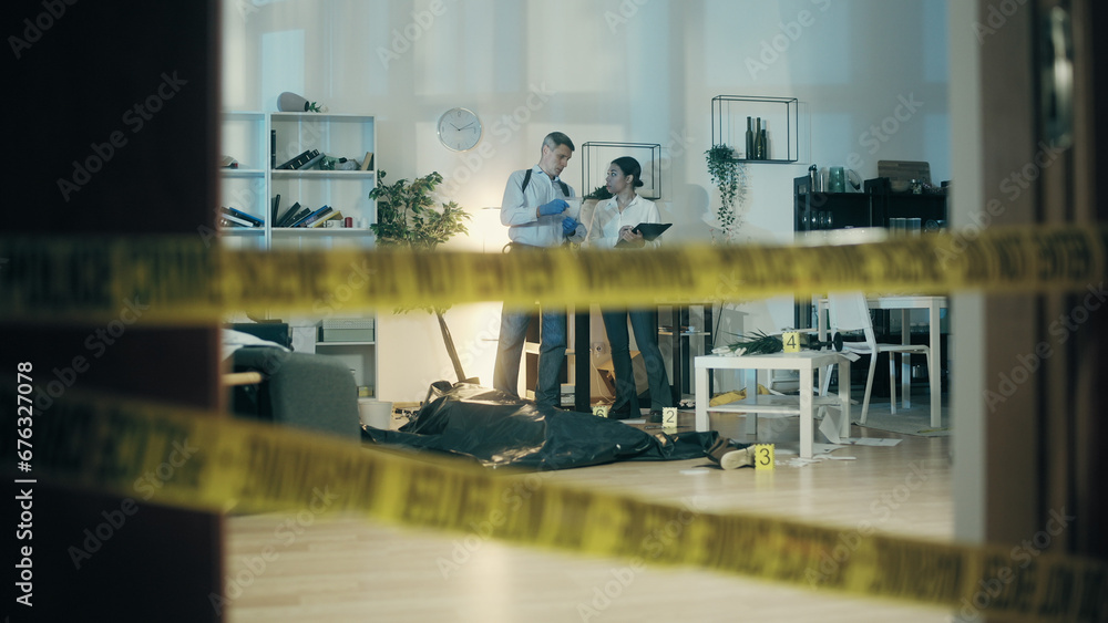 Police detective are working at the crime scene during a murder ...