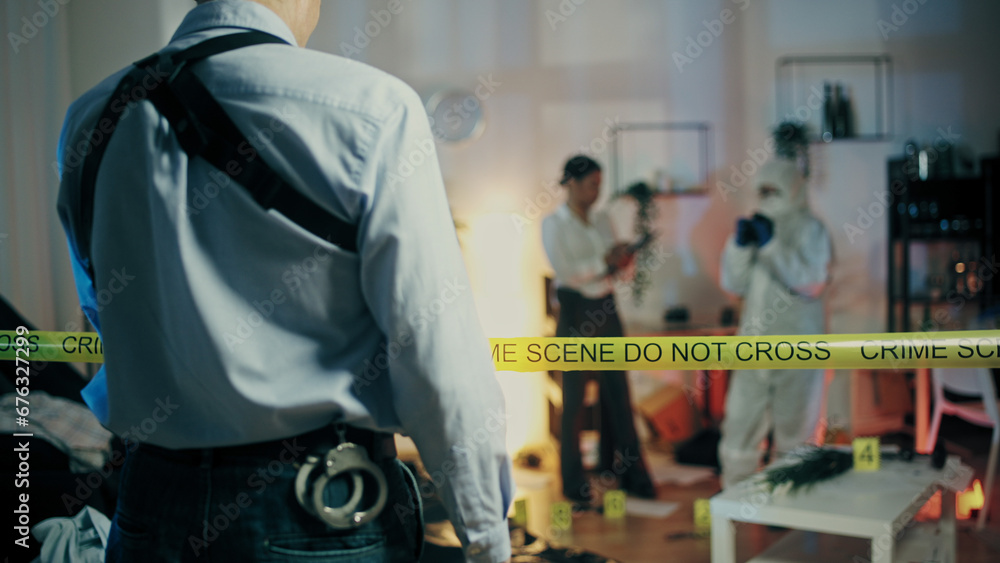 The back view of a detective entering the crime scene where his ...
