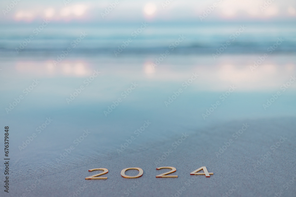 gold numbers 2024 on the sand by the sea Stock Photo | Adobe Stock