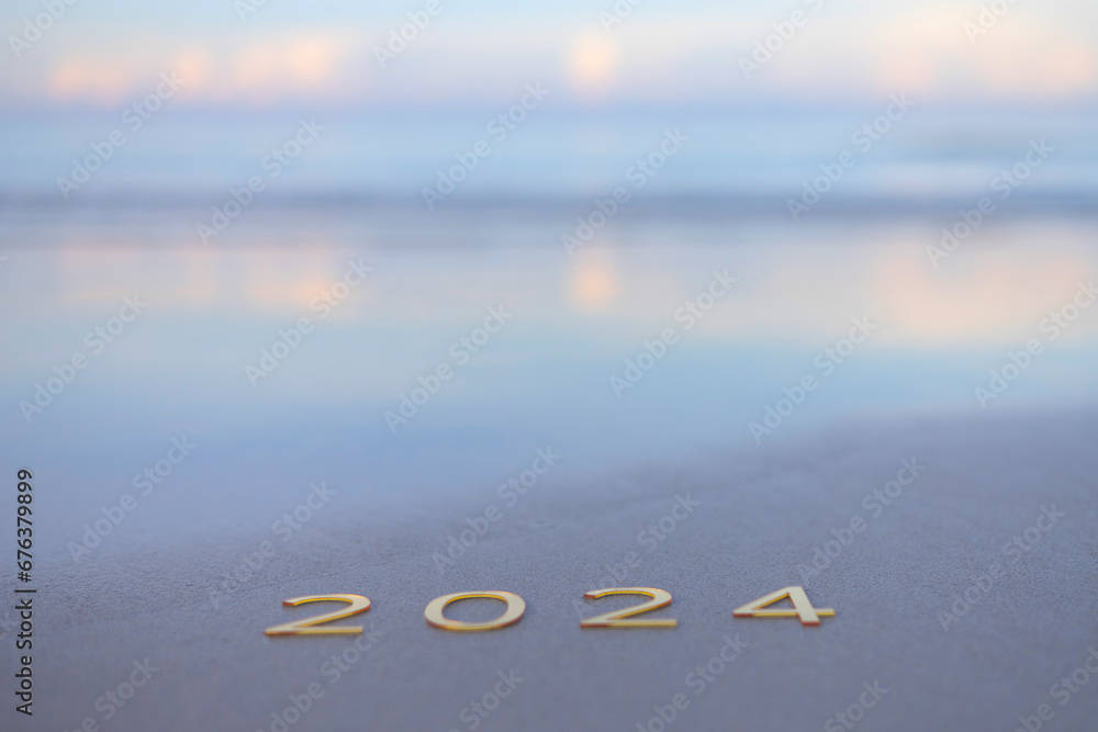 gold numbers 2024 on the sand by the sea Stock Photo | Adobe Stock