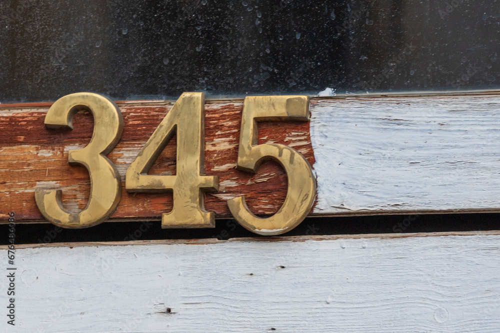 345 golden. numbers. Part of the wooden weathered door frame. Learning ...