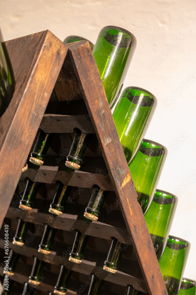Wooden pupitre with bottles. Production of cremant sparkling wine in ...