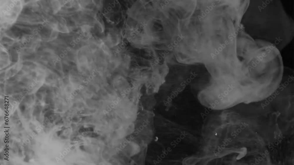 Shroud of White Smoke on Black. White smoke hangs floridly in the air ...