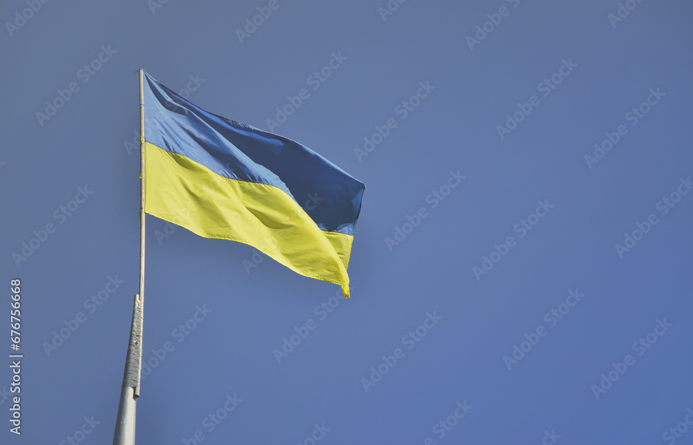 Ukrainian flag against the blue cloudless sky. The official flag of the ...