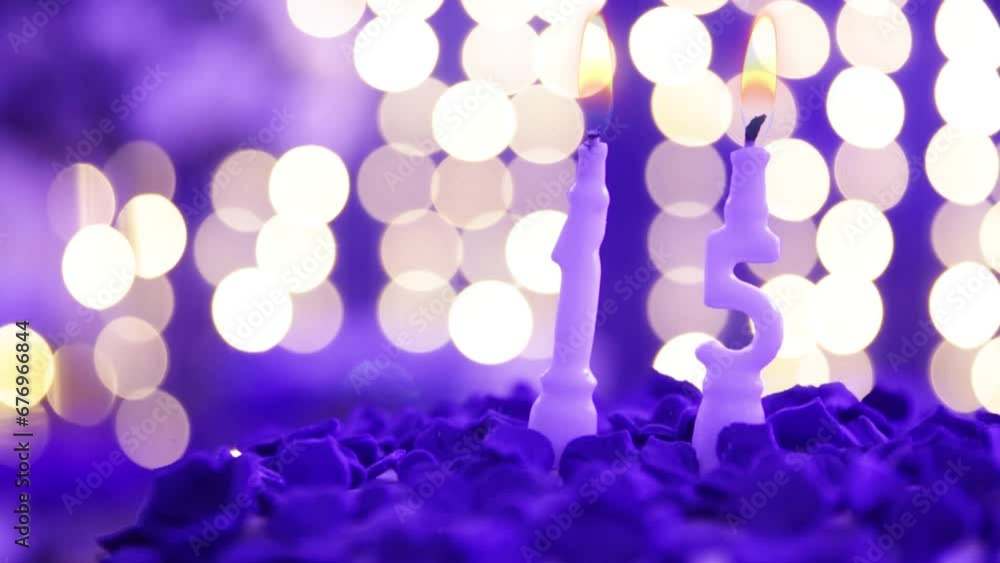 15th birthday cake with lit candle and purple background with blurred ...