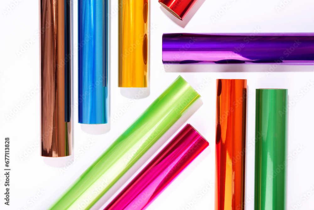 Different colorful glossy wrapping paper rolls on white background ...