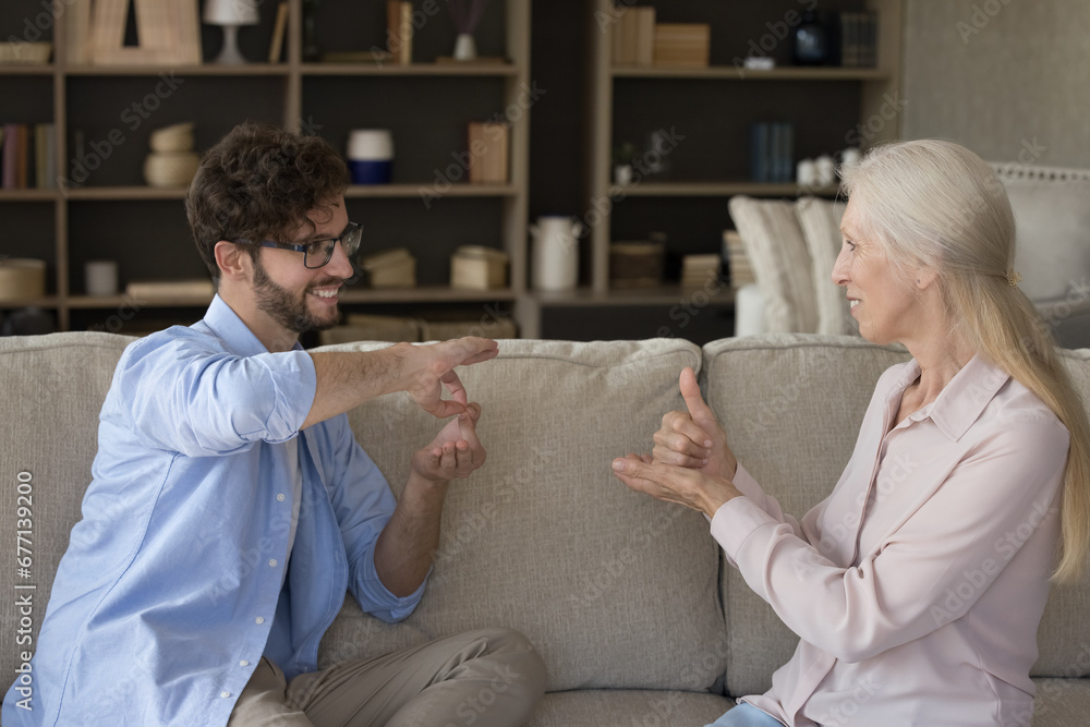 Millennial grown up son communicates with older mother using gestures ...