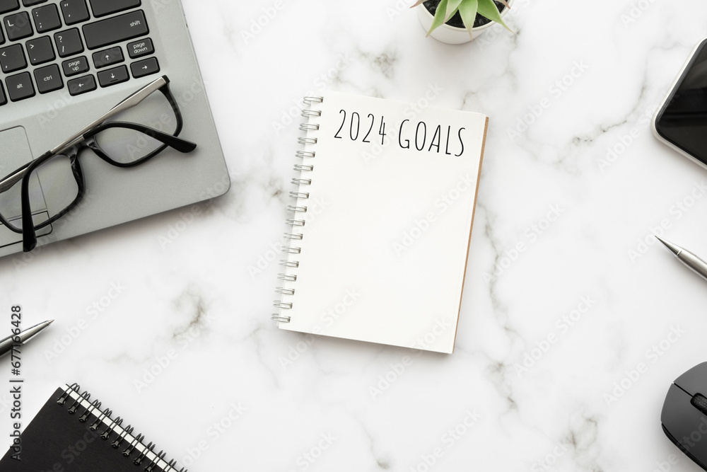 Notebook with 2024 goals text on it to apply new year resolutions and ...