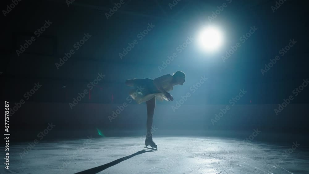 Female Figure Skater Spinning On Ice In Ice Rink, Silhouette View ...