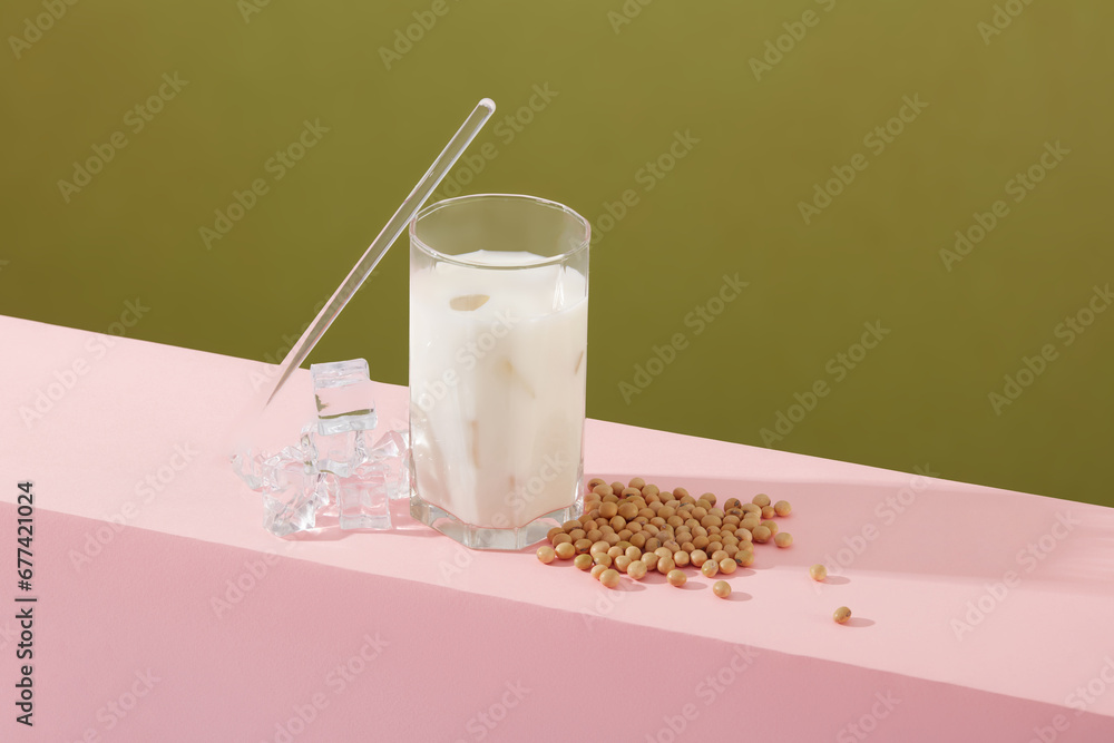 A pile of soybeans decorated with a milk cup, a straw and some ices ...